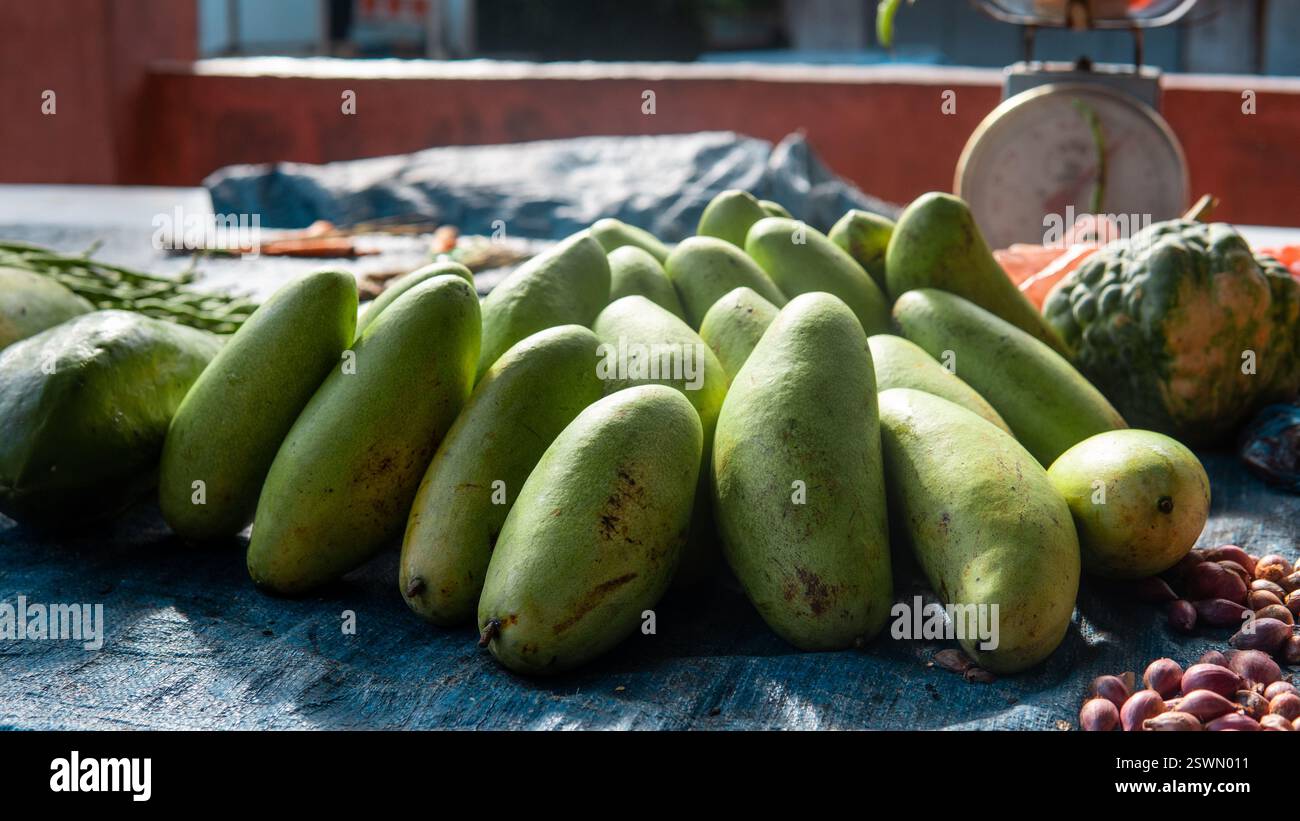Fresh mangoes displayed in a traditional Indonesian market, showcasing ...