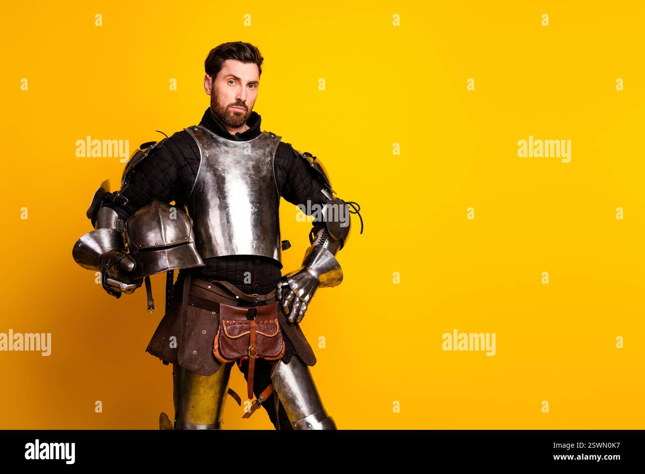 Portrait of a man in medieval armor with a vibrant yellow background ...