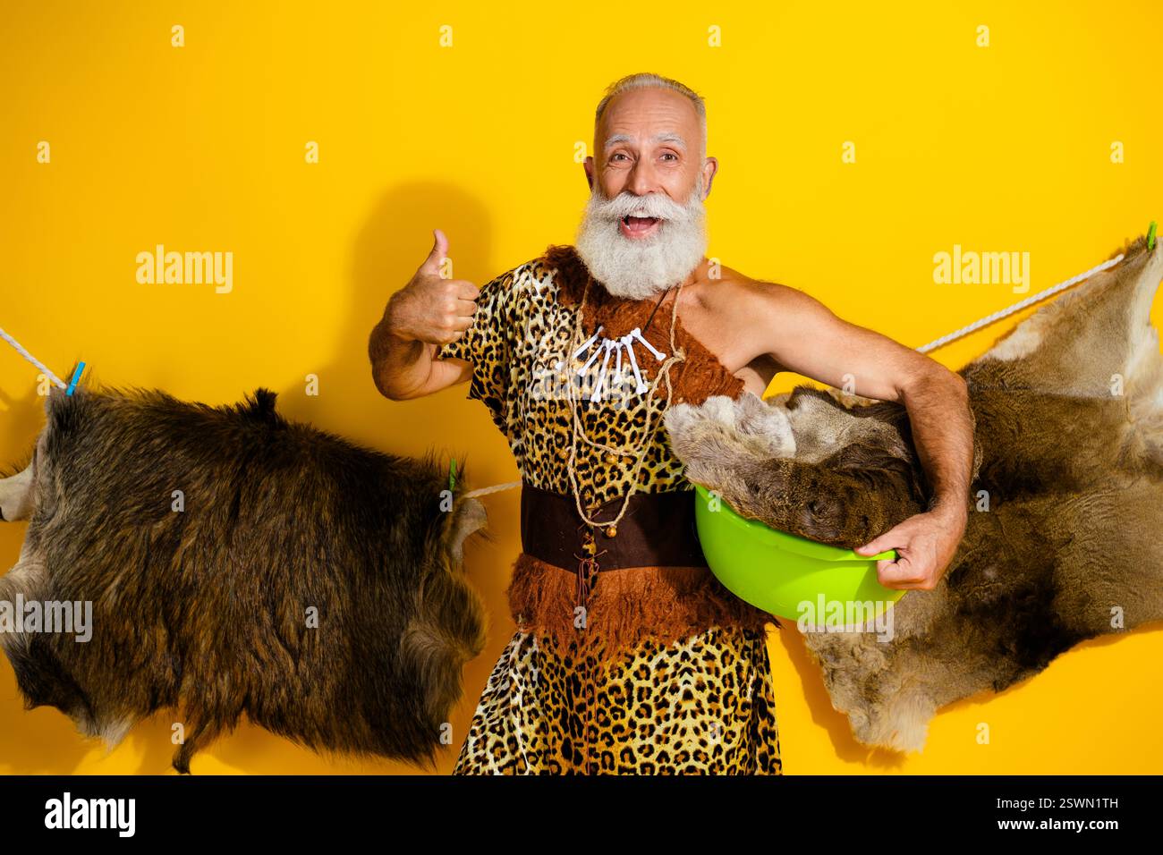 Photo of old caveman hold basket with anima skin make thumb up symbol ...