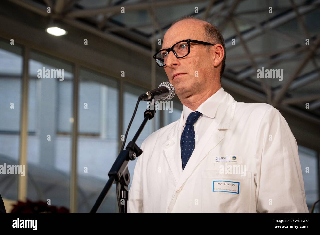 The surgeon Dr. Sergio Alfieri speaks to reporters in the lobby of the ...