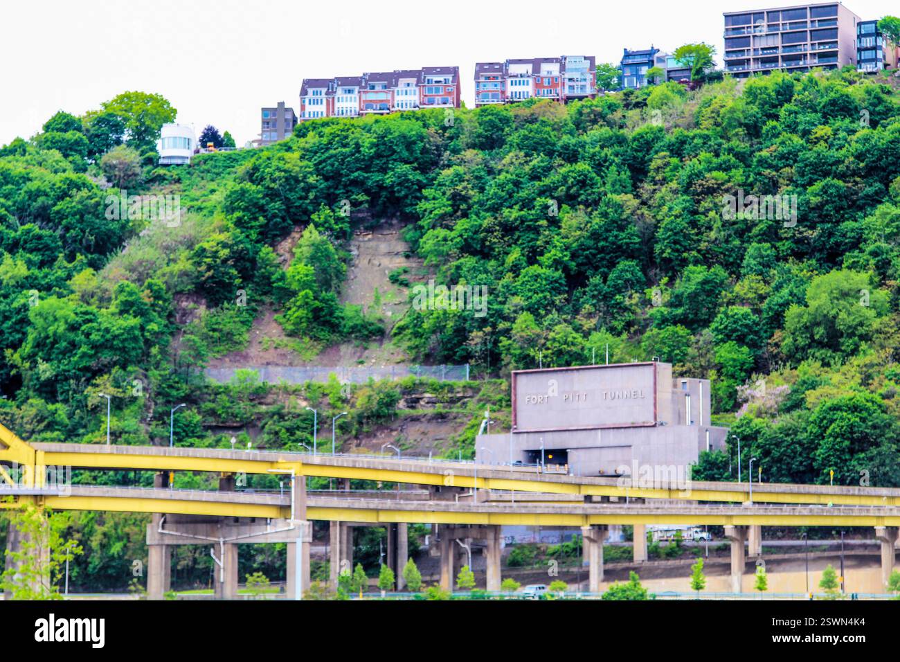 View of Fort Pitt Tunnel entrance with colorful homes on the hillside ...