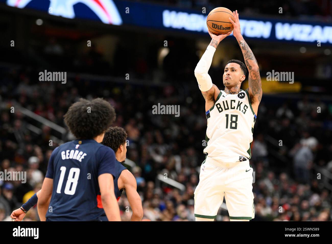 Milwaukee Bucks forward Kyle Kuzma, right, looks to shoot against ...