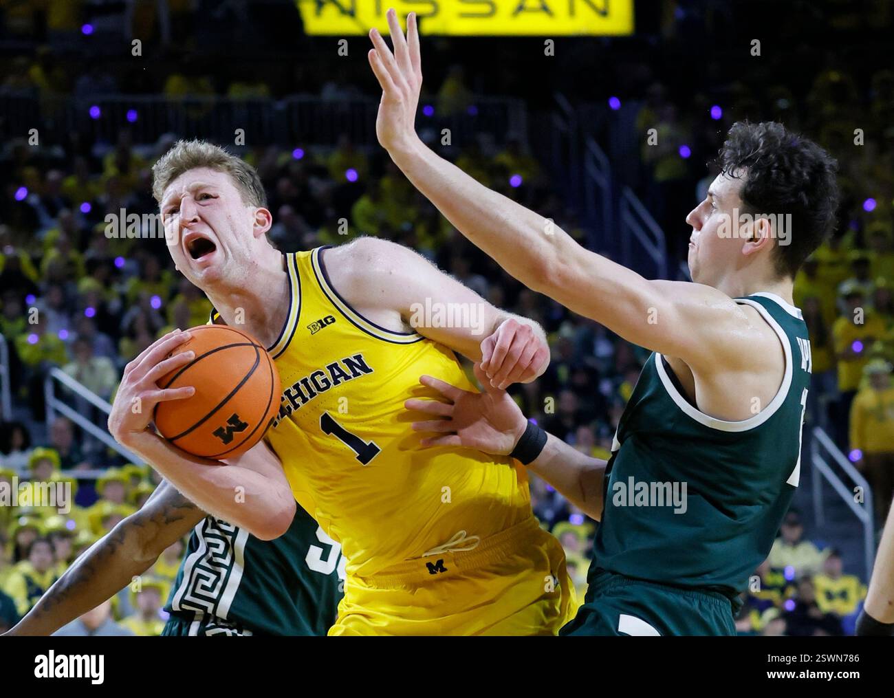 Michigan center Danny Wolf (1) collides with Michigan State center ...
