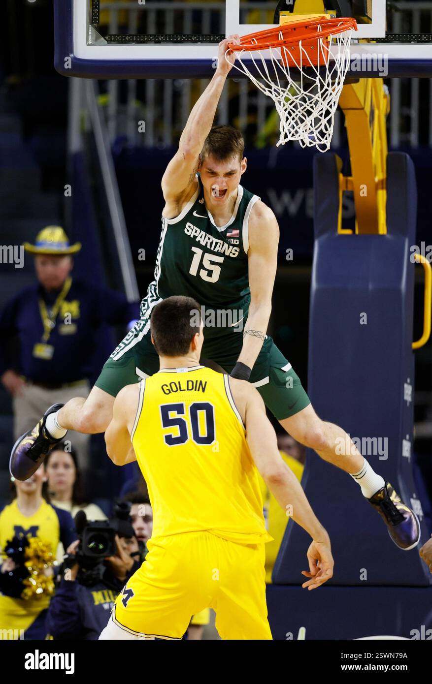 Michigan State center Carson Cooper (15) hangs from the rim after ...