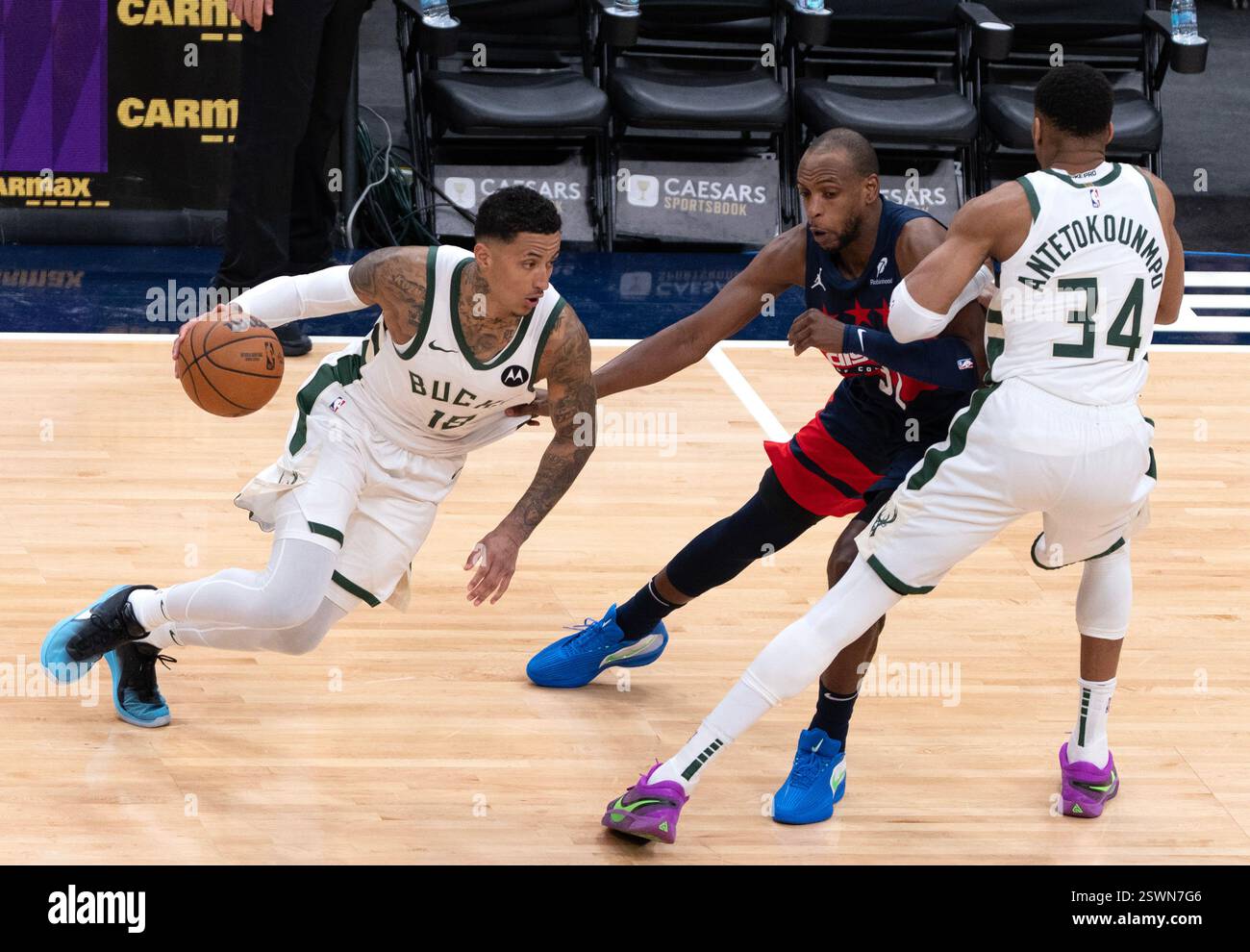 WASHINGTON, DC - FEBRUARY 21: Milwaukee Bucks forward Kyle Kuzma (18) dribbles past Washington ...