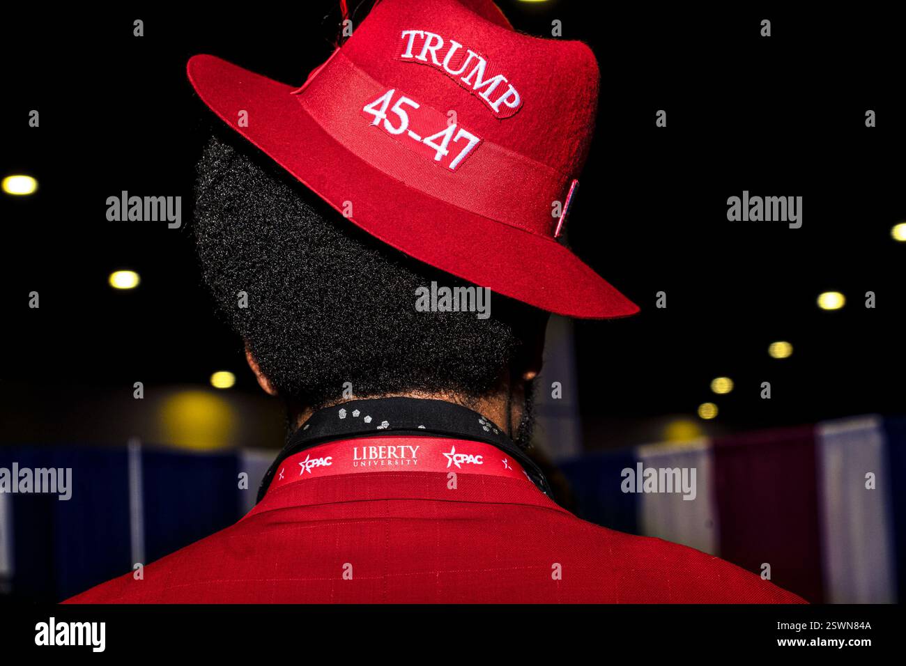 An attendee wears a red velvet Trump fedora at CPAC 25, in Washington ...