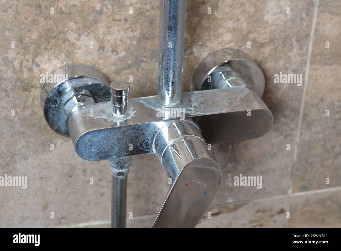 Dirty faucet with salt deposits from water in bathroom on marble modern ...