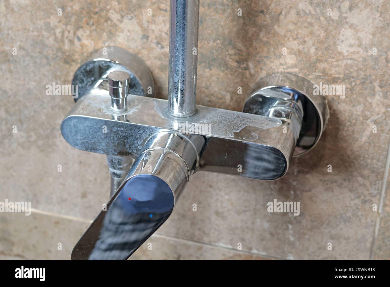 Dirty faucet with salt deposits from water in bathroom on marble modern ...