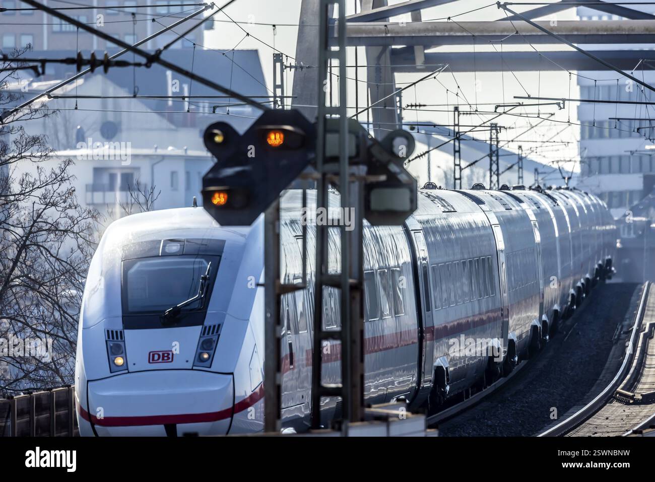 ICE en route on a railway bridge with tracks and signalling system ...