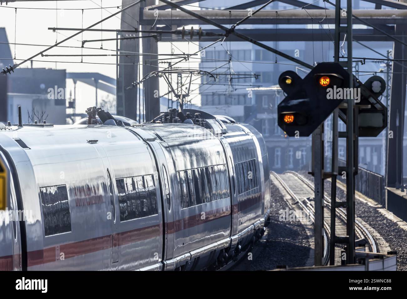 ICE en route on a railway bridge with tracks and signalling system ...