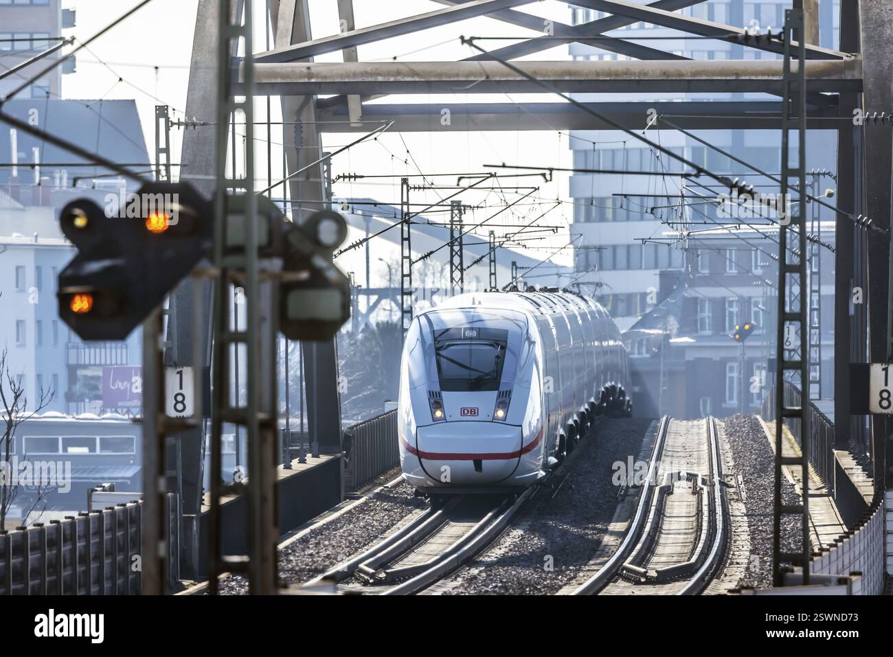 ICE en route on a railway bridge with tracks and signalling system ...