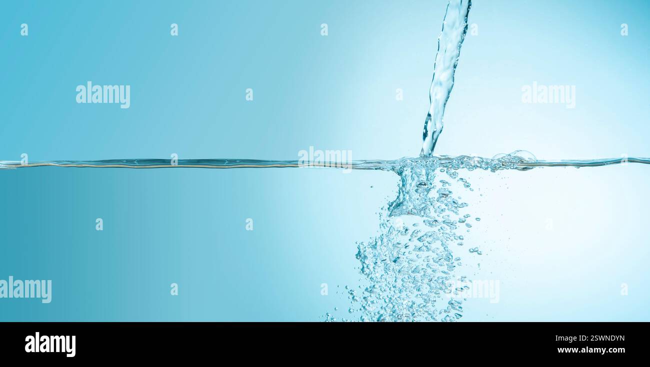 Front view of water jet filling a water tank with bubbles against blue ...