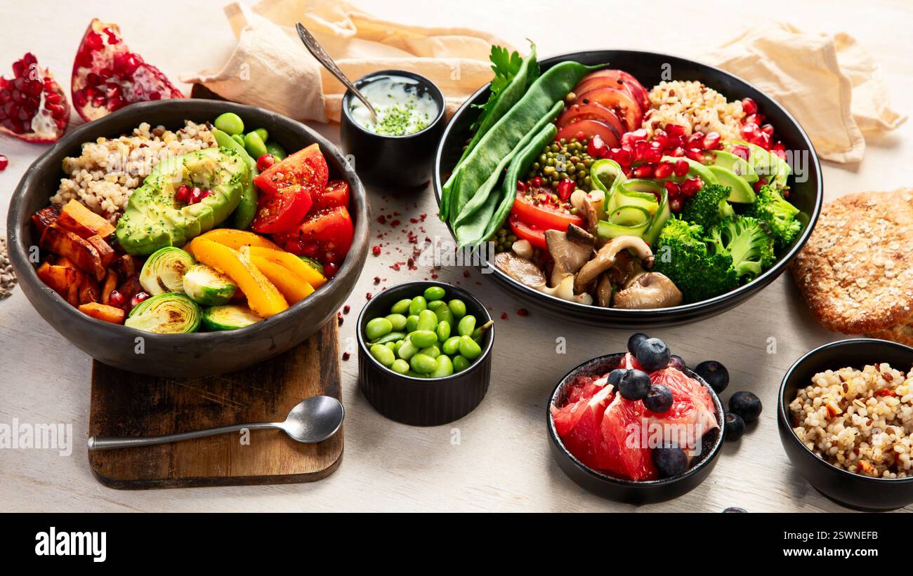 Buddha bowls of mixed vegetables for vegans on a light background. Healthy eating concept. Top ...