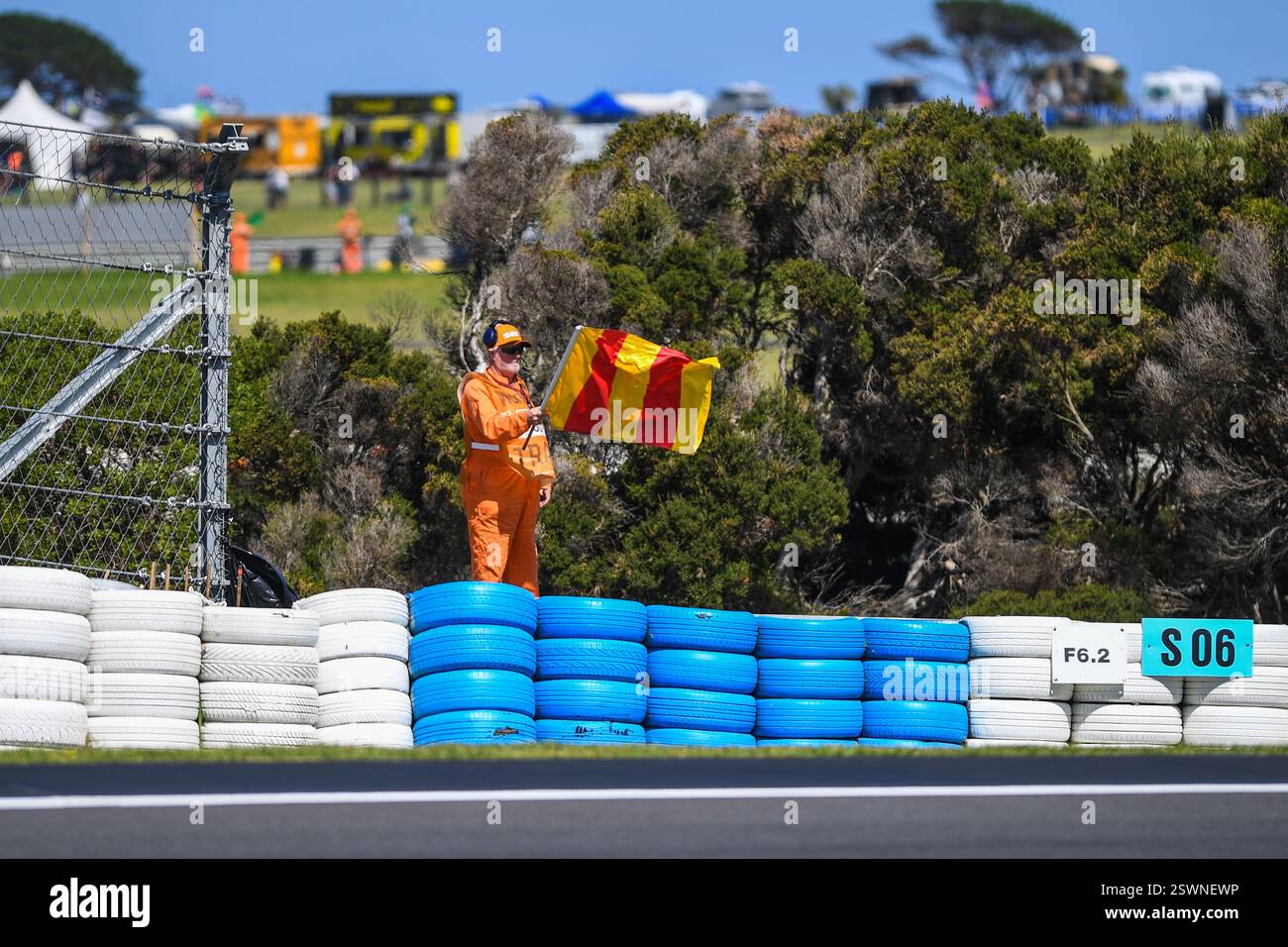 Track marshal is seen in signalling restart of the race after major oil spill stop during Day 1 ...