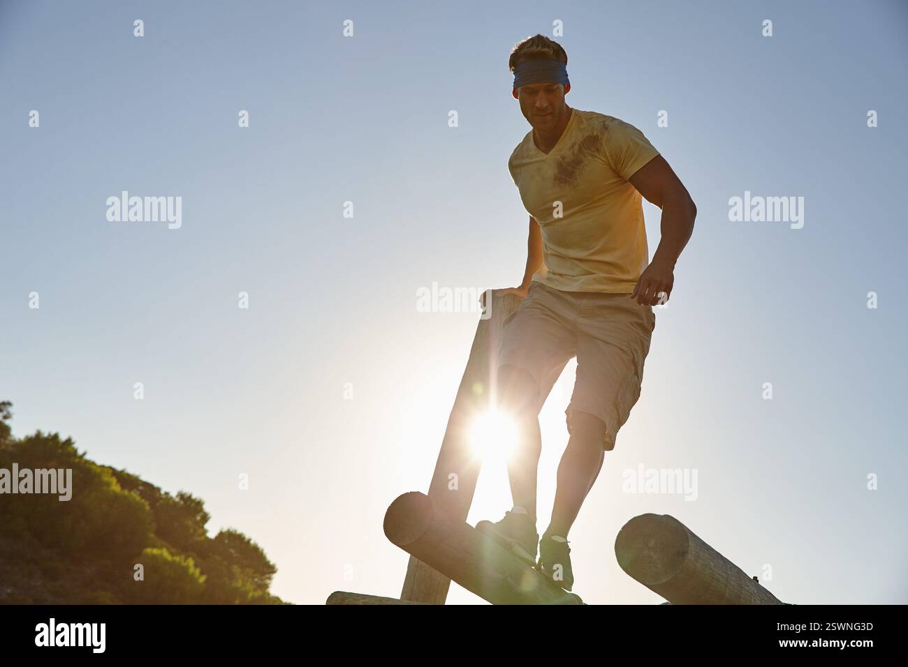 Athlete man, jumping and course of obstacle for physical strength, army ...