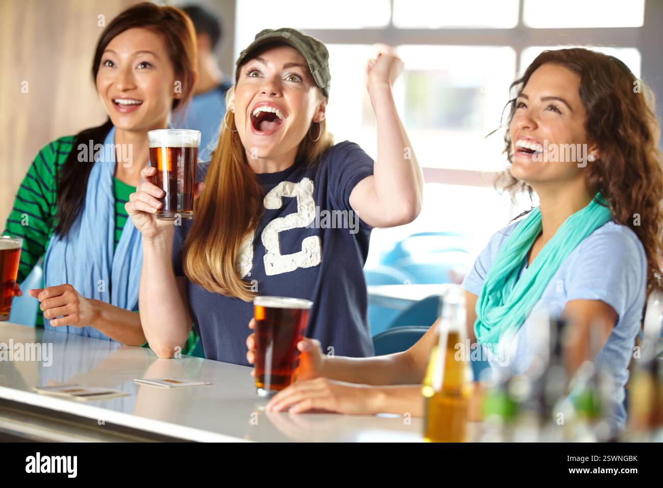 Excited, beer and women in pub with cheers, game goal and sports for ...