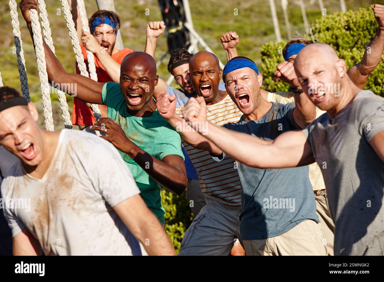 Bootcamp, motivation and portrait with army men on rope of obstacle ...