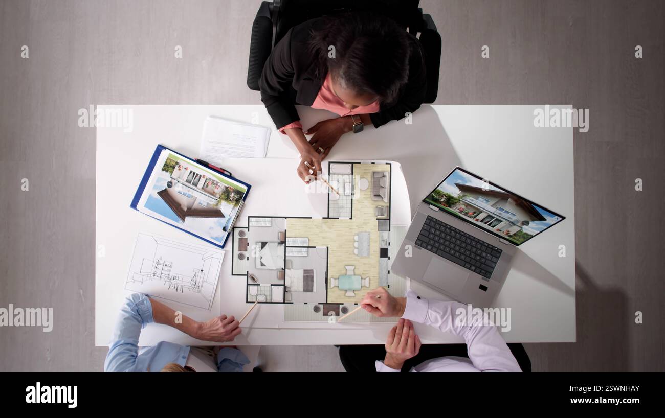 Real Estate Agent Discussing House Plan with Diverse Couple Clients ...