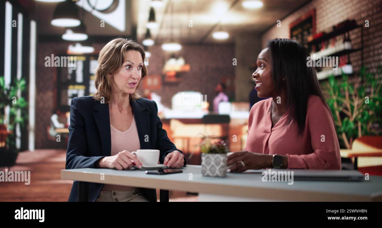 African American graphic designer and older lady manager collaborating ...