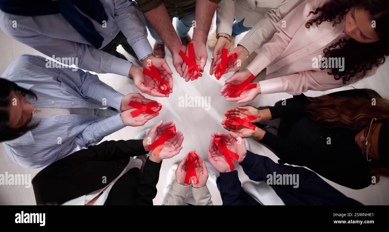 Supporting HIV AIDS patients through charity with red awareness ribbon ...