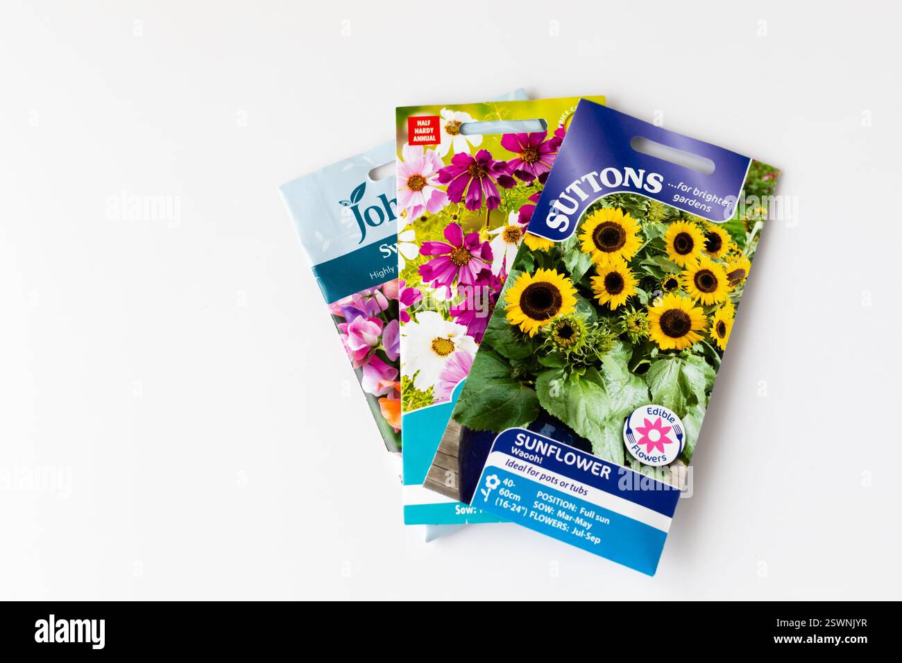 Three packets of flower seeds on a white background Stock Photo - Alamy