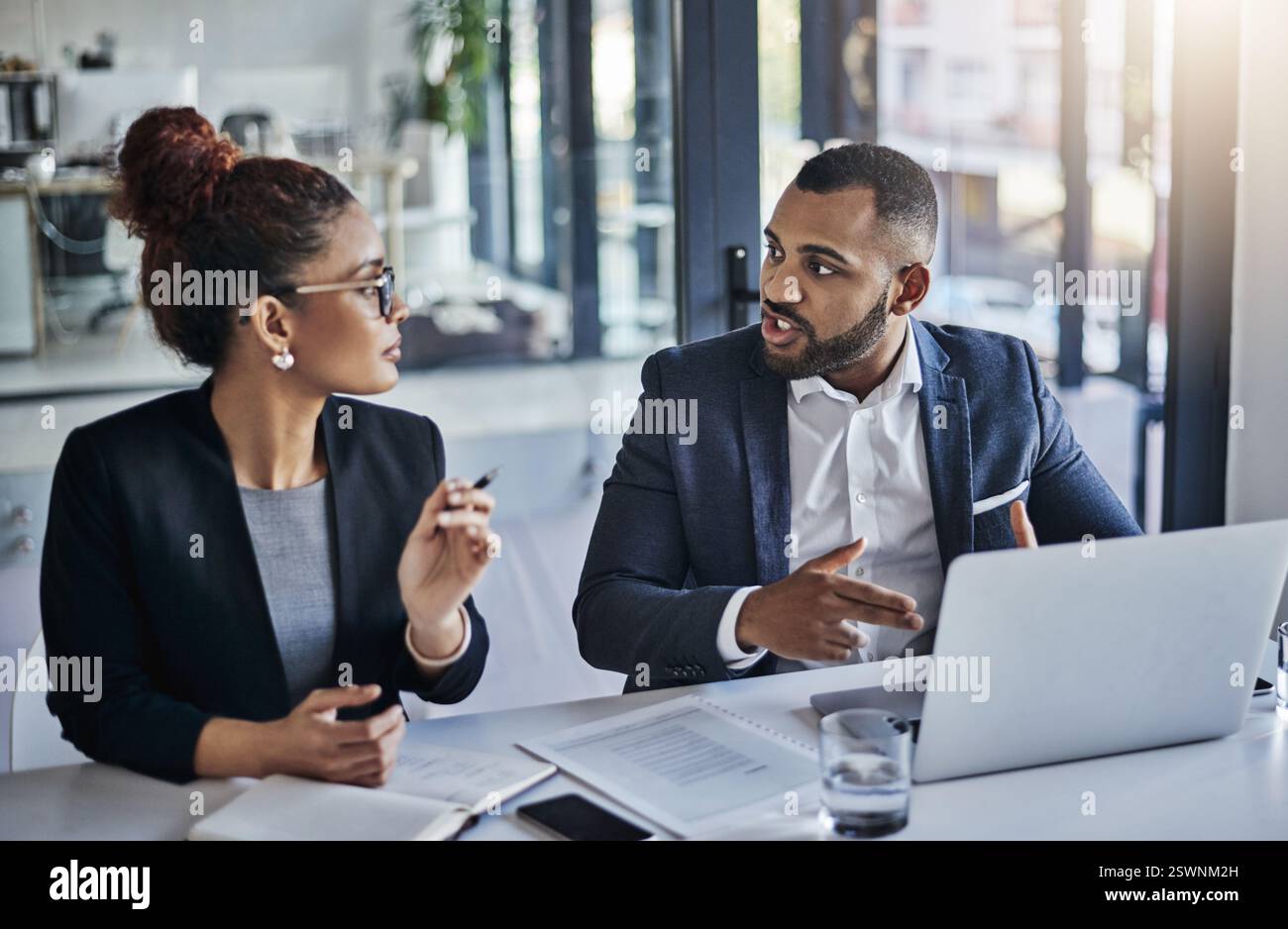 Teamwork, laptop and performance review with business people in office ...