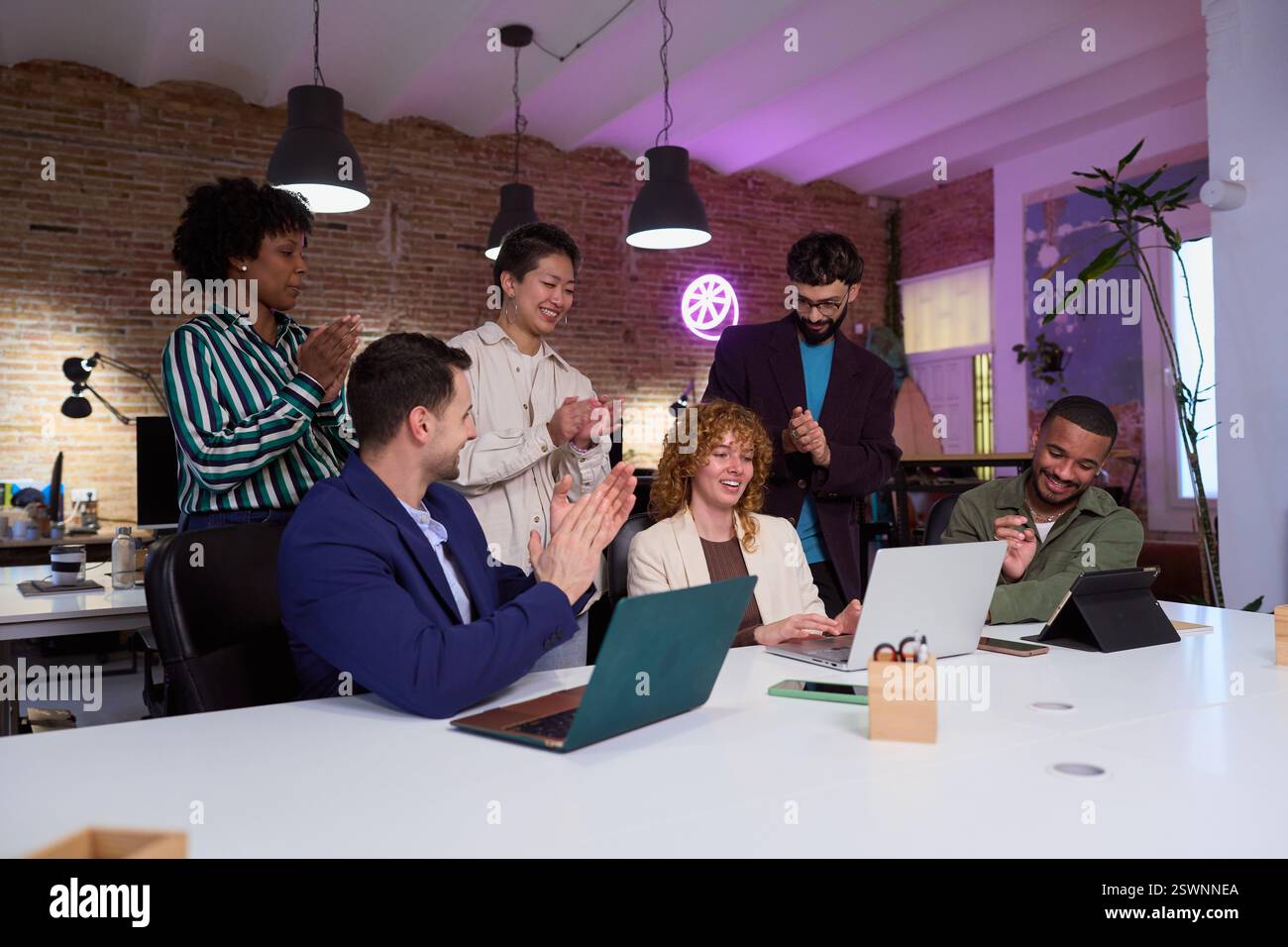 Happy business team clapping hands during a meeting Stock Photo - Alamy