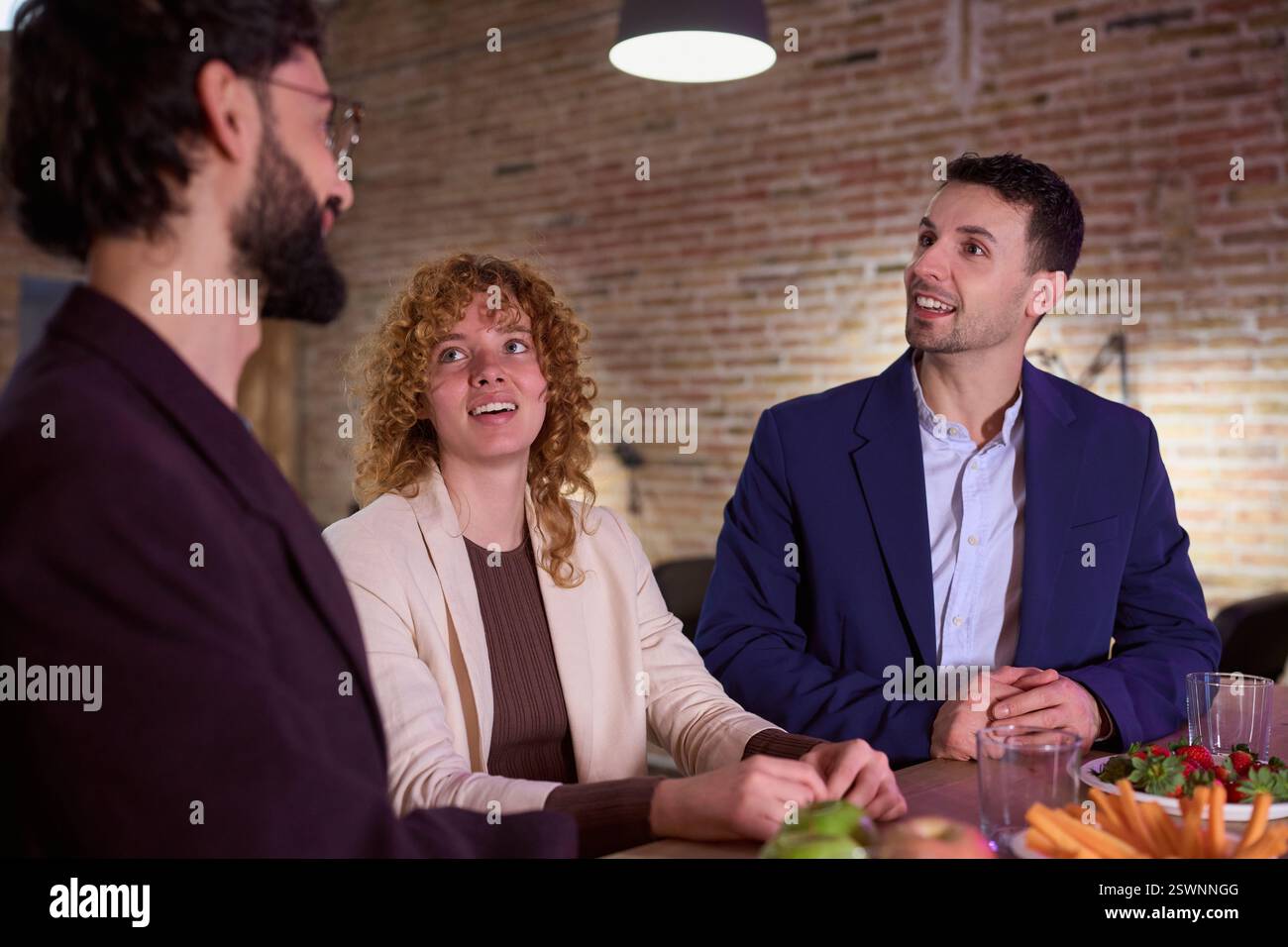 Business people having informal meeting while eating healthy food in ...