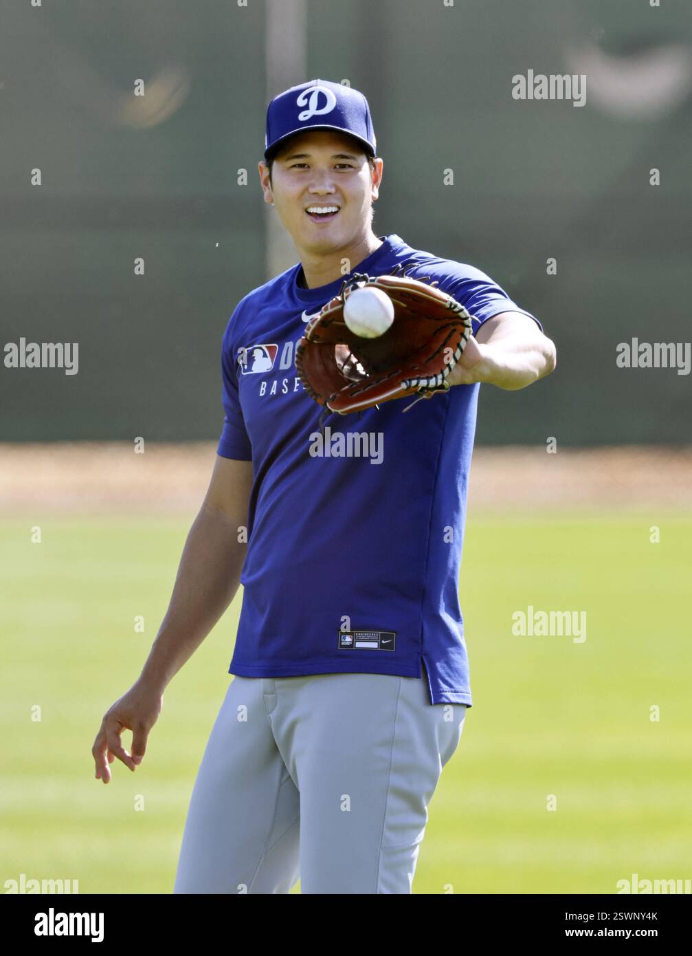Shohei Ohtani of the Los Angeles Dodgers plays catch during the club's ...