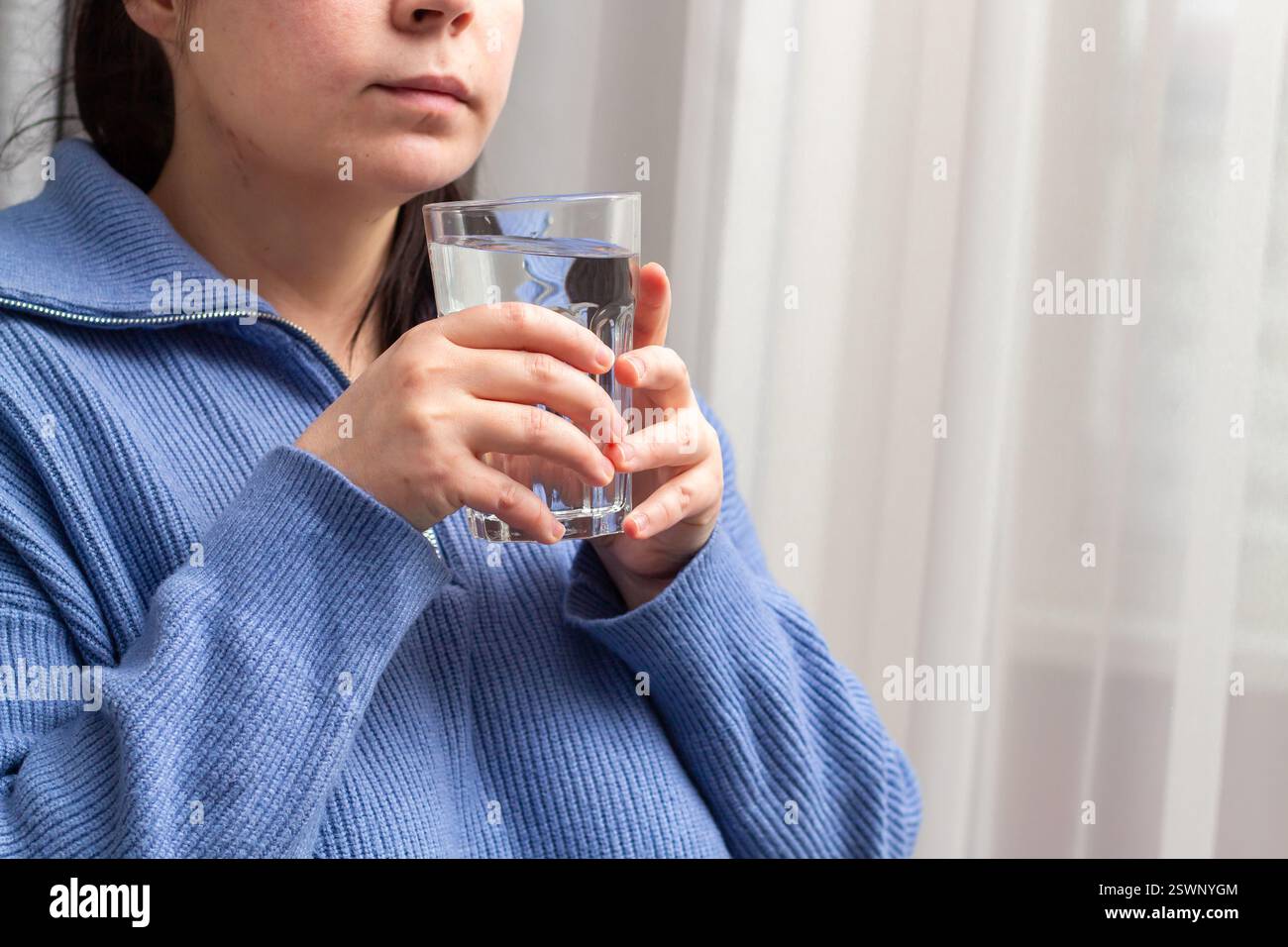 Woman with acne drinking water. Water as important life component. Skin ...