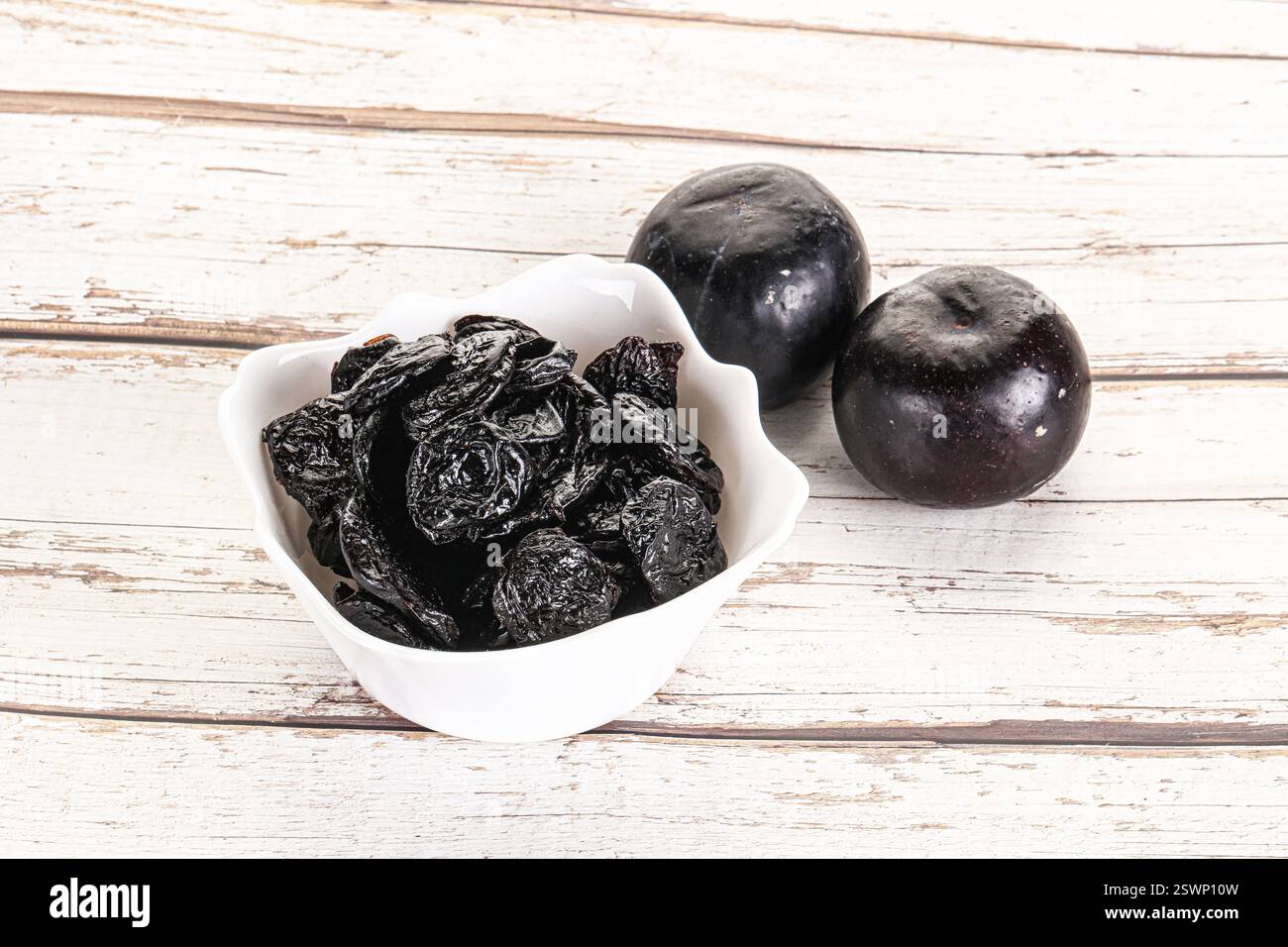 Dry sweet prunes in thw bowl Stock Photo - Alamy
