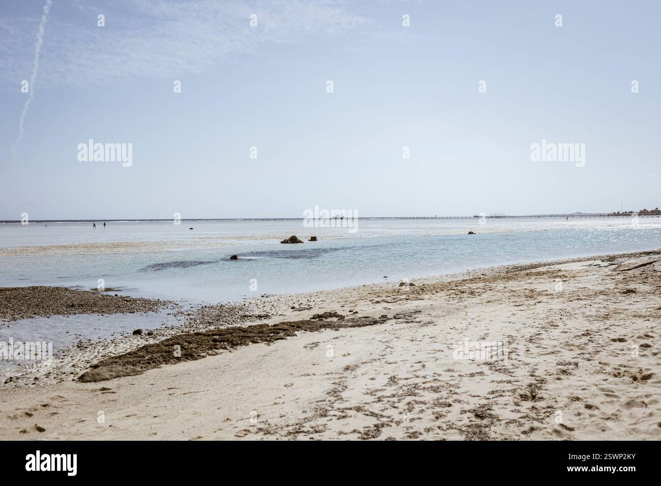 Crystal-clear shallow water gently lapping against the sandy shore ...