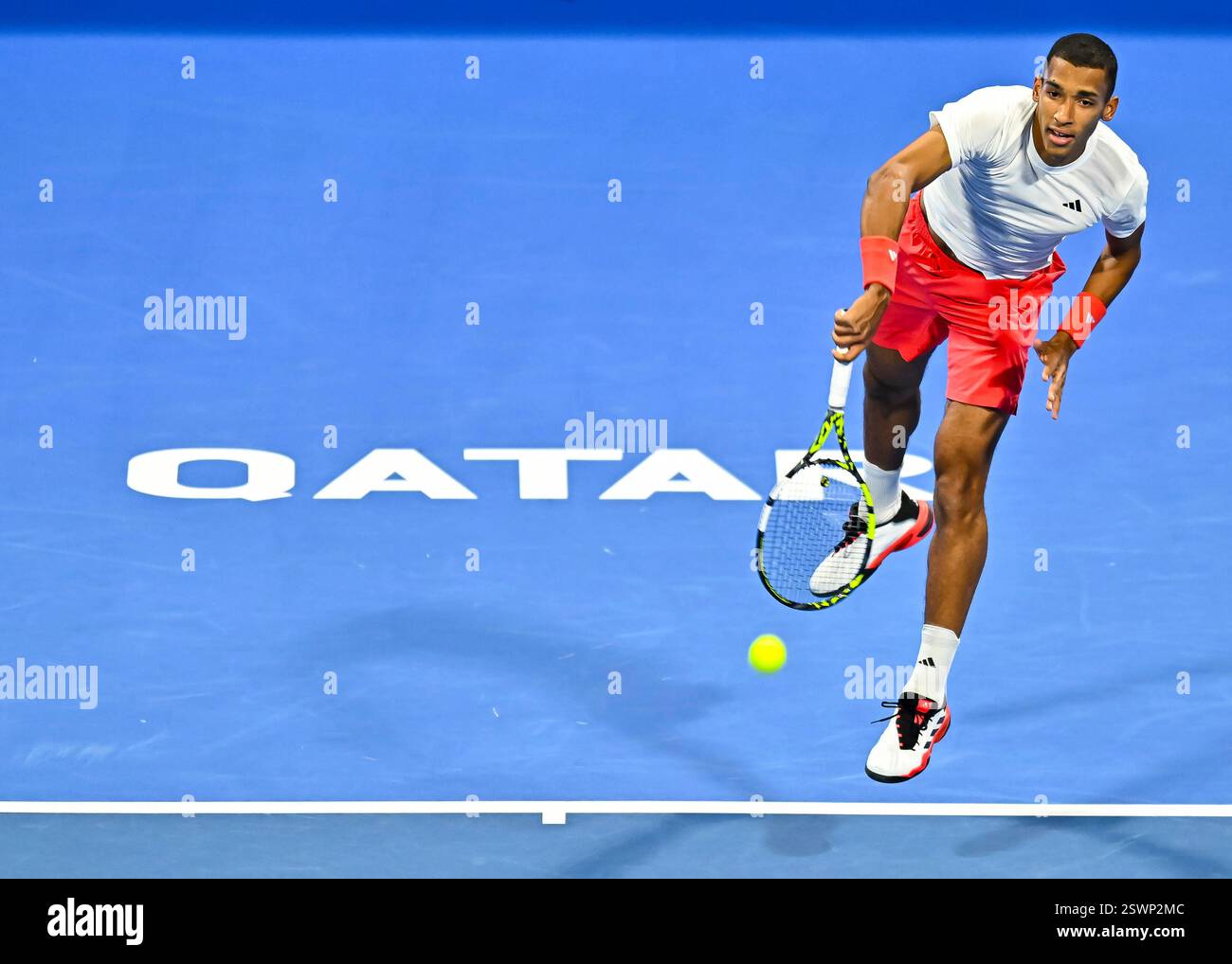 Doha, Qatar. 21st Feb, 2025. Felix Auger-Aliassime of Canada serves during the men's singles ...