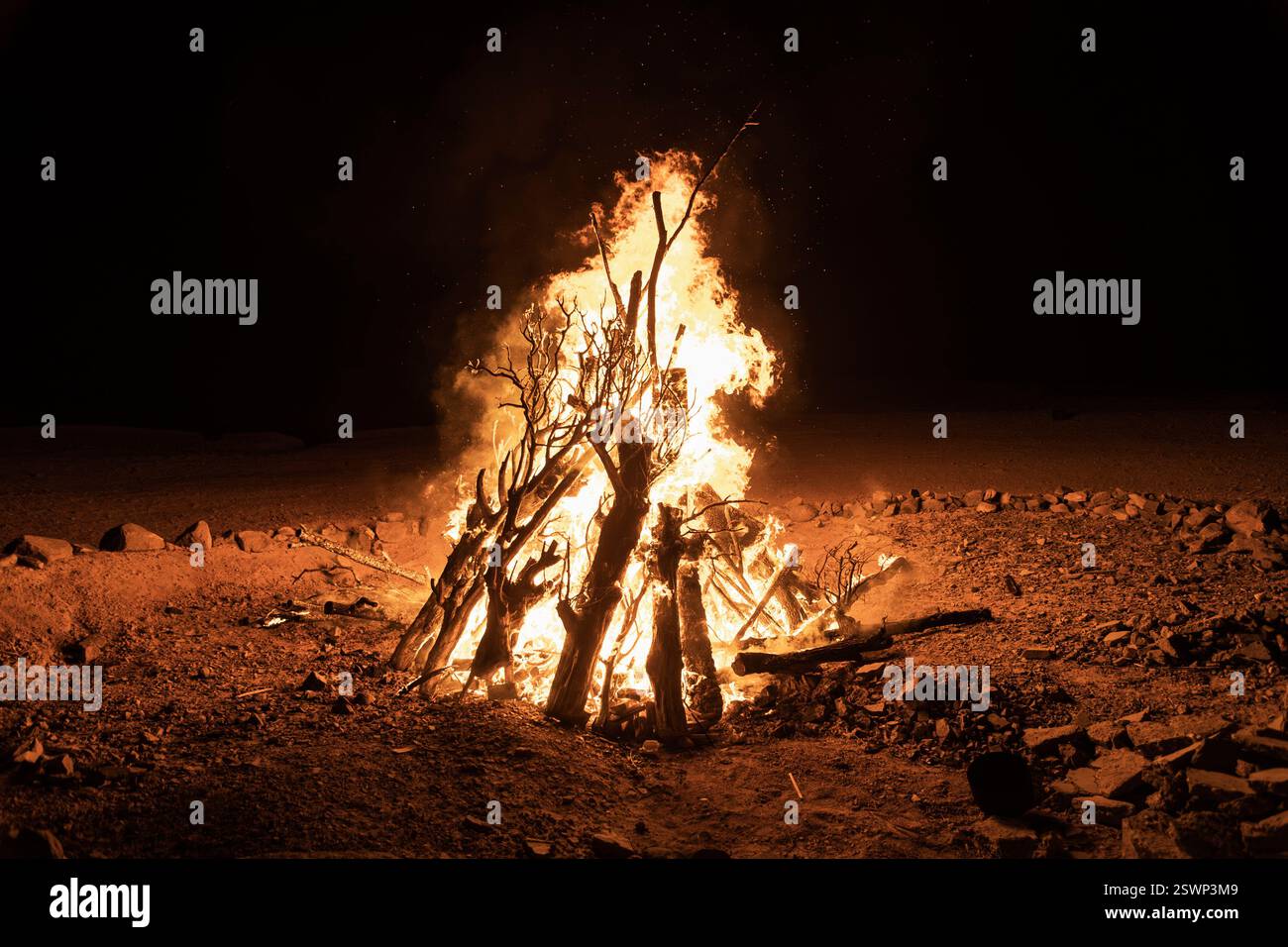 Large bonfire burning in the desert of marsa alam, egypt, creating a ...
