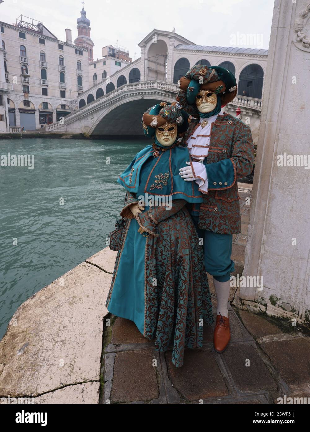 Venice, Italy. 22nd Feb, 2025. Revellers by Rialto Bridge in colourful ...