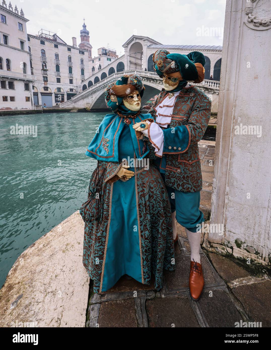 Venice, Italy. 22 February 2025 Revellers by Rialto Bridge in colourful ...