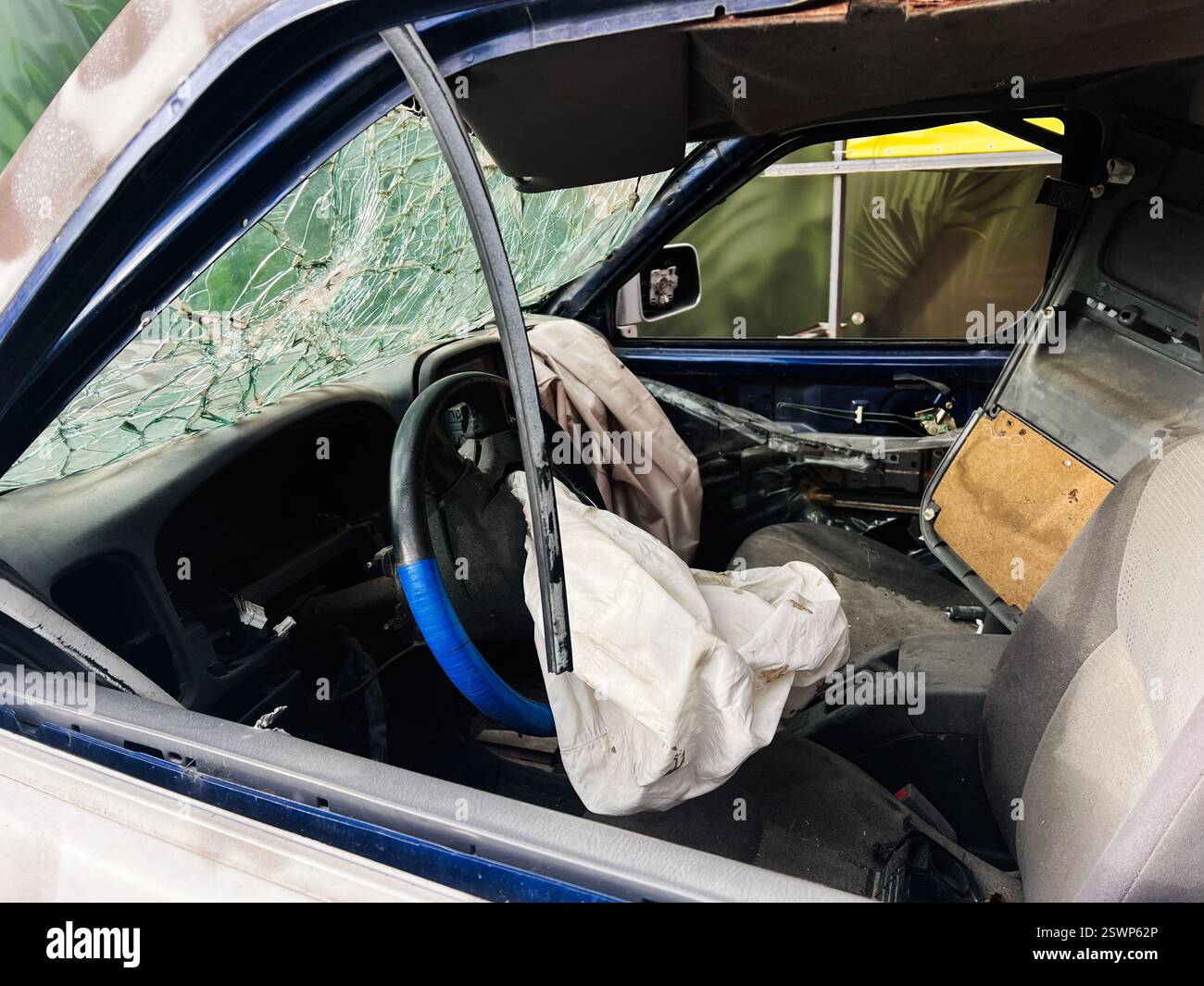 Damaged military car interior with deployed airbag and broken ...