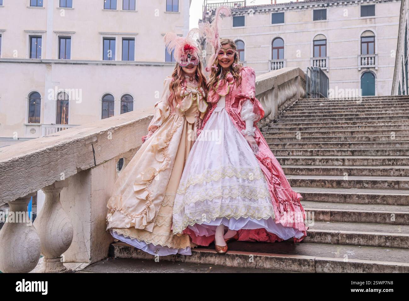 venice, Italy. 22 February 2025 Revellers by Rialto Bridge in colourful ...