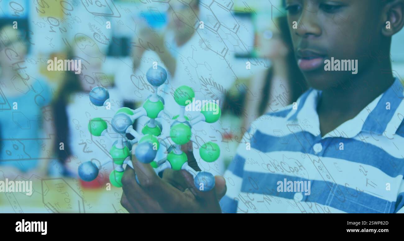 Holding molecular model, child studying science over mathematical ...