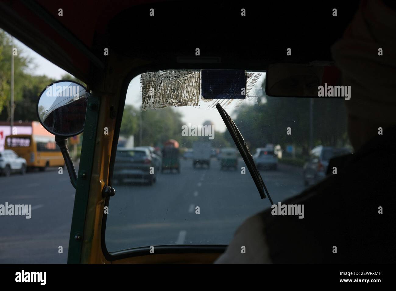 View from inside an autorickshaw as it navigates afternoon traffic in ...