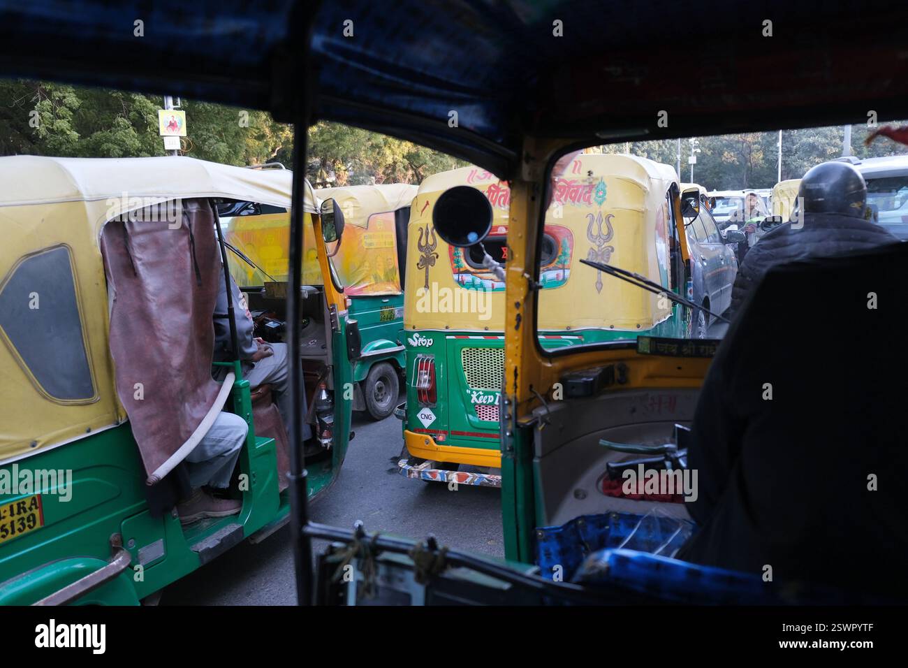 View from inside an autorickshaw as it navigates afternoon traffic in ...
