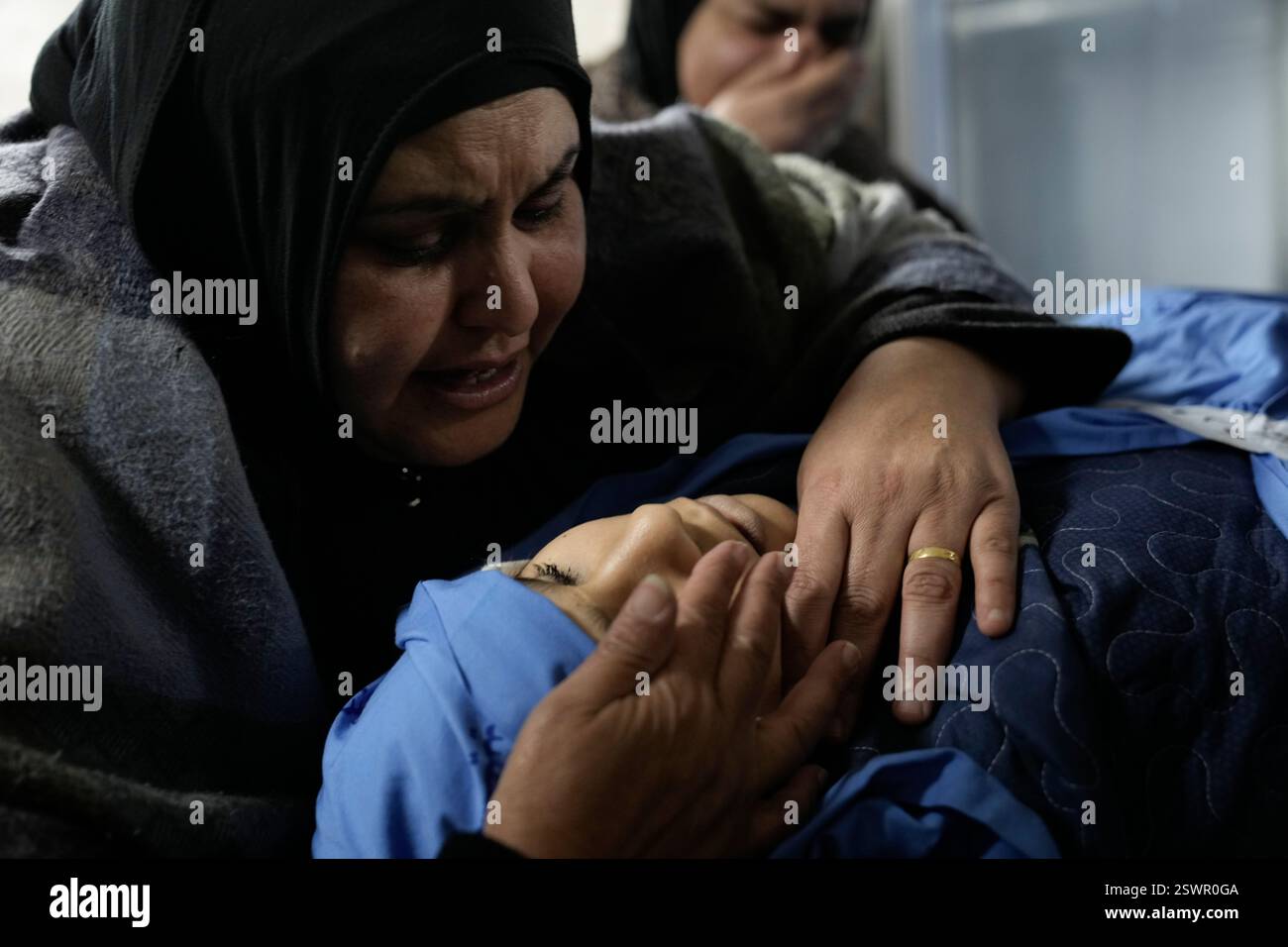 Radina Al-Amouri mourns over the body of her daughter Rimas, 13, who ...
