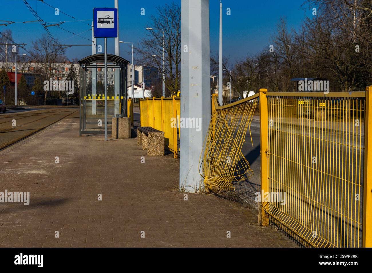 Road accident scene, damaged net at the bus stop, car hit the fence ...