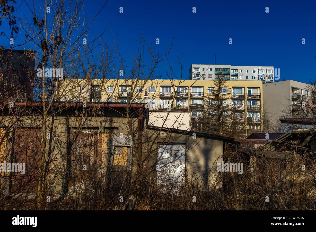 Old abandoned buildings in the center of a modern housing estate ...