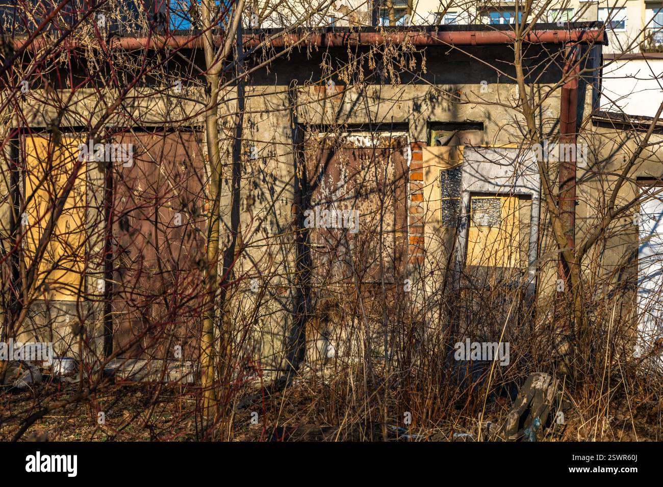 Old abandoned buildings in the center of a modern housing estate ...