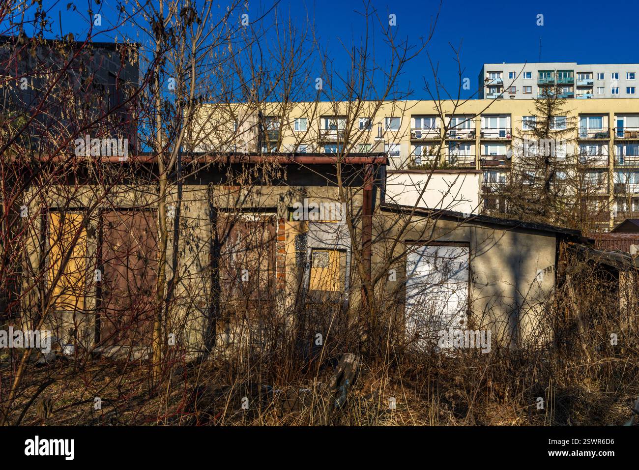 Old abandoned buildings in the center of a modern housing estate ...
