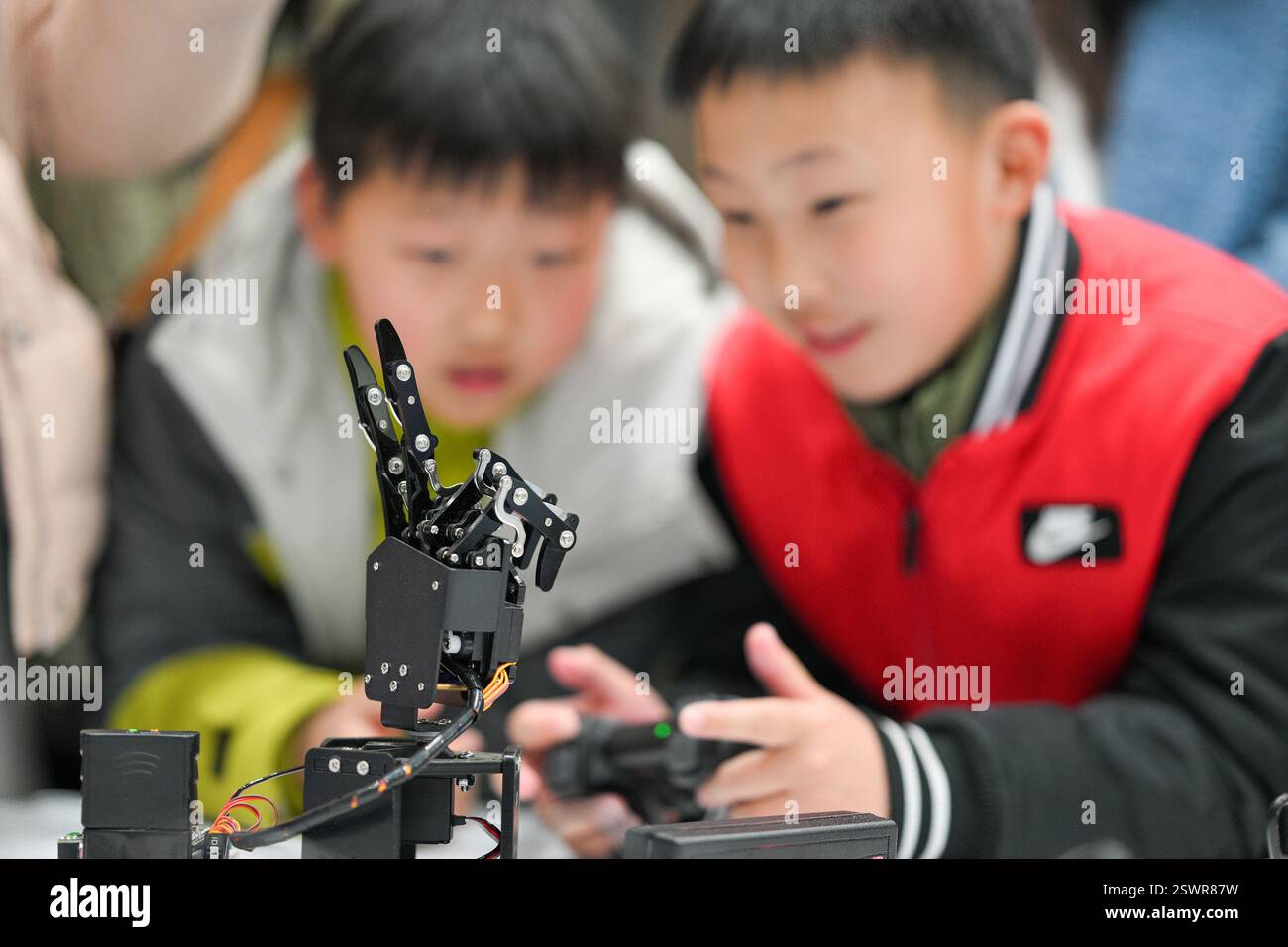 NANJING, CHINA - FEBRUARY 22, 2025 - A child experiences manipulating a ...