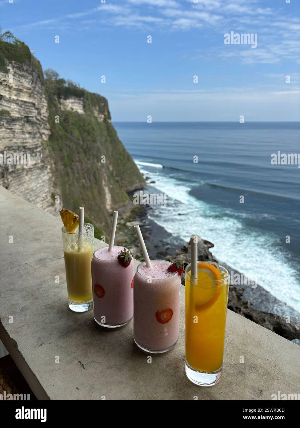 Four Drinks on the Railing at Malini Restaurant Uluwatu with Ocean and ...
