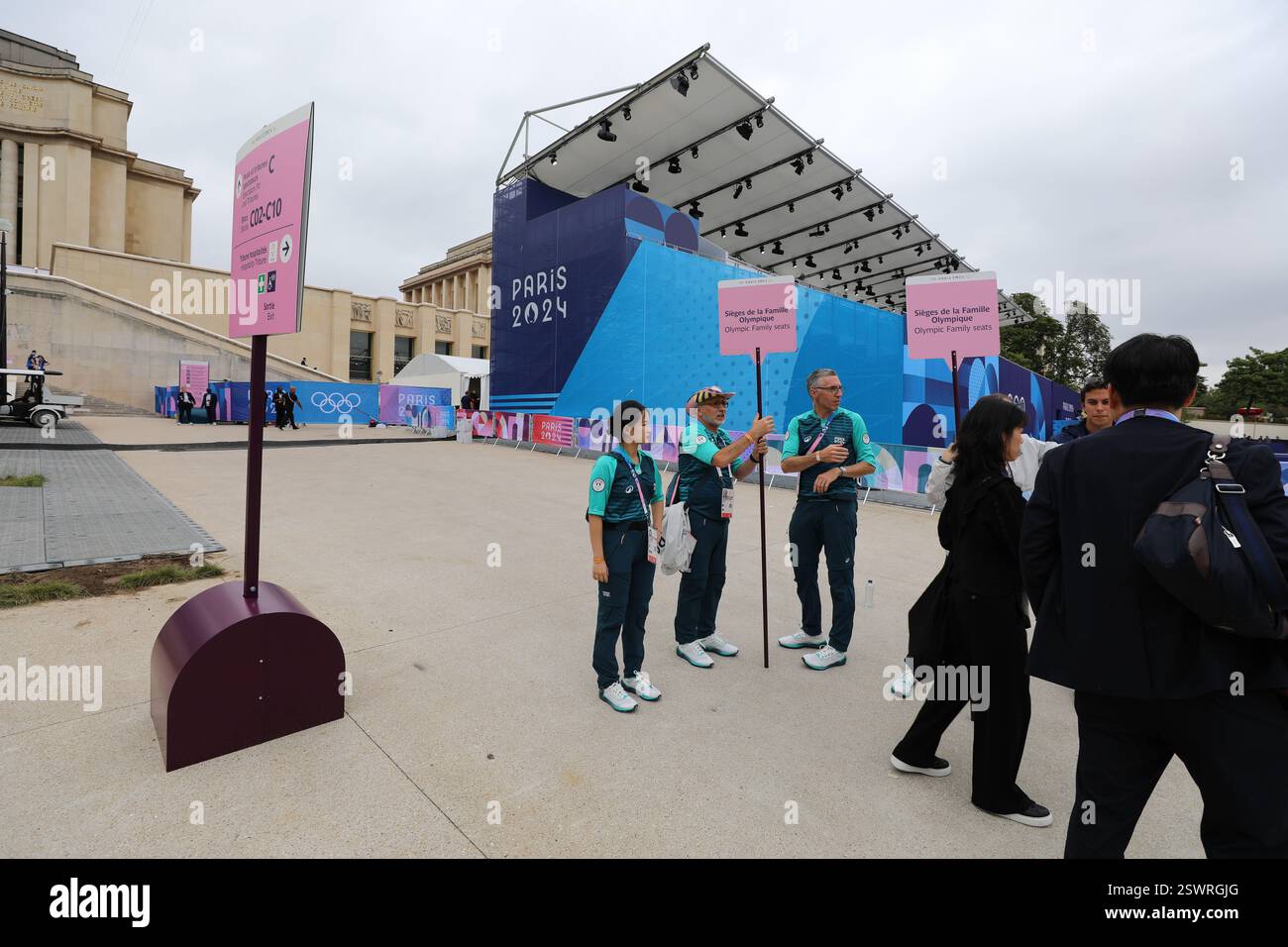July 26th, 2024 - Paris, France: Volunteers hold signs for spectators ...