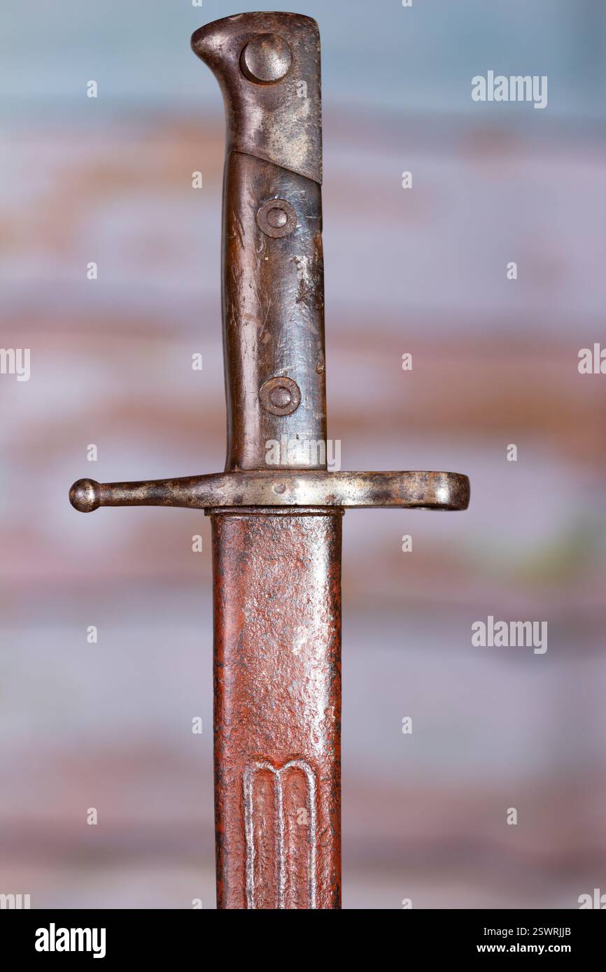 Rustic close-up view of a vintage sword's handle and blade with aged ...